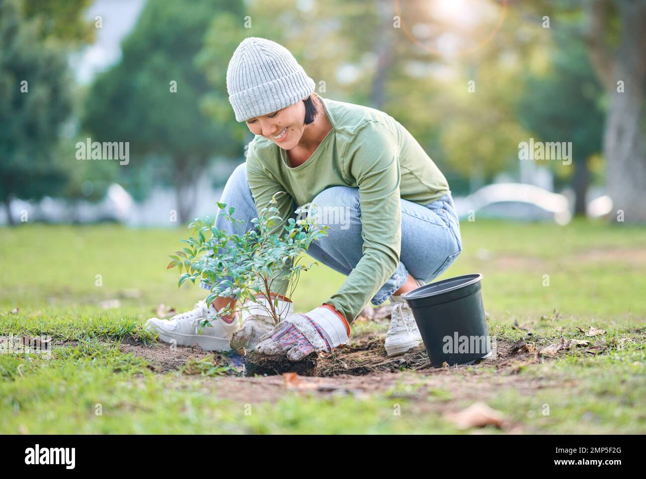 Nature, plant and woman gardening in a park for sustainable ...