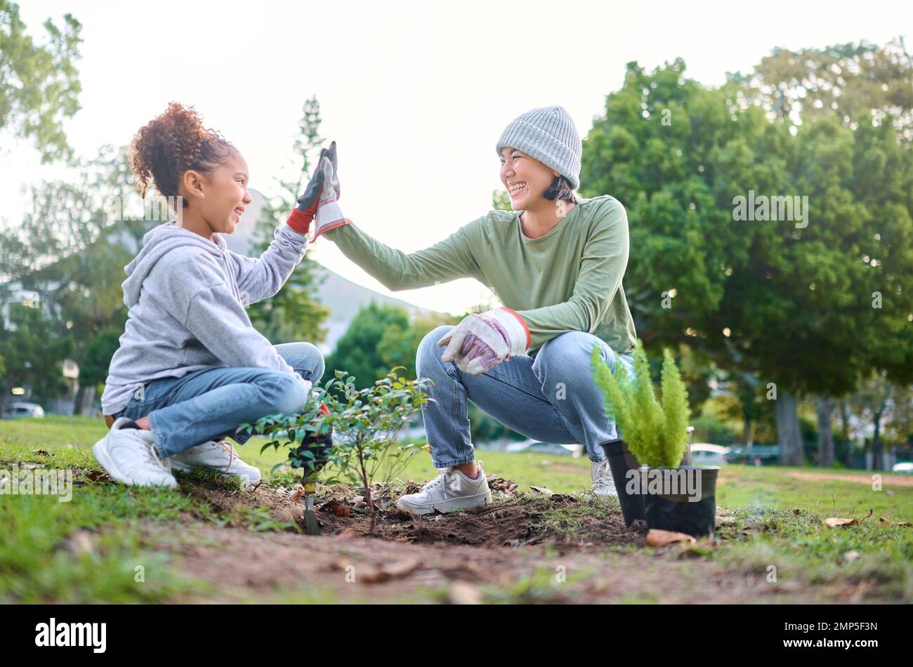 High five, child and woman with plant for gardening, ecology and ...