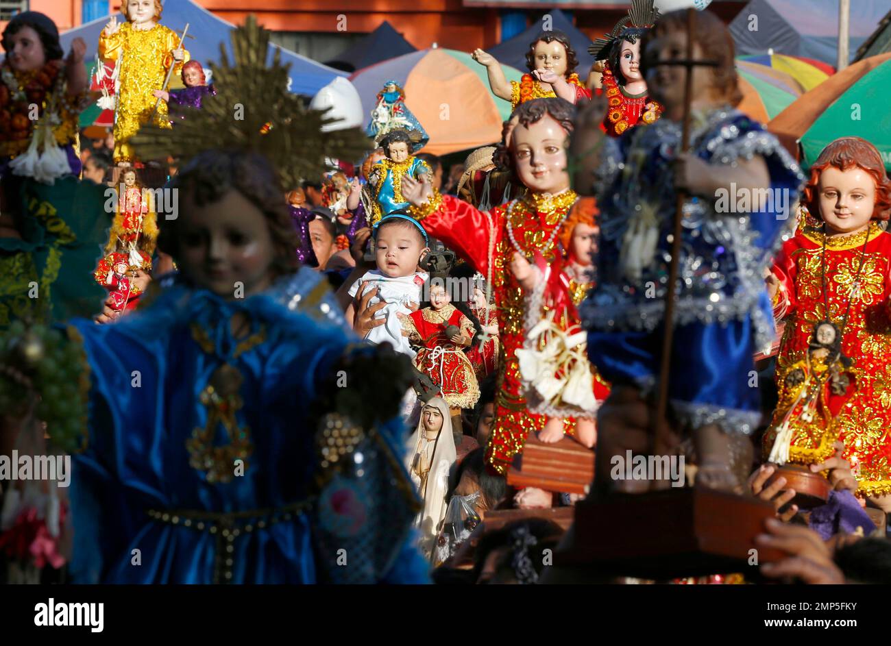 Images of the Baby Jesus, along with babies, are blessed with holy ...