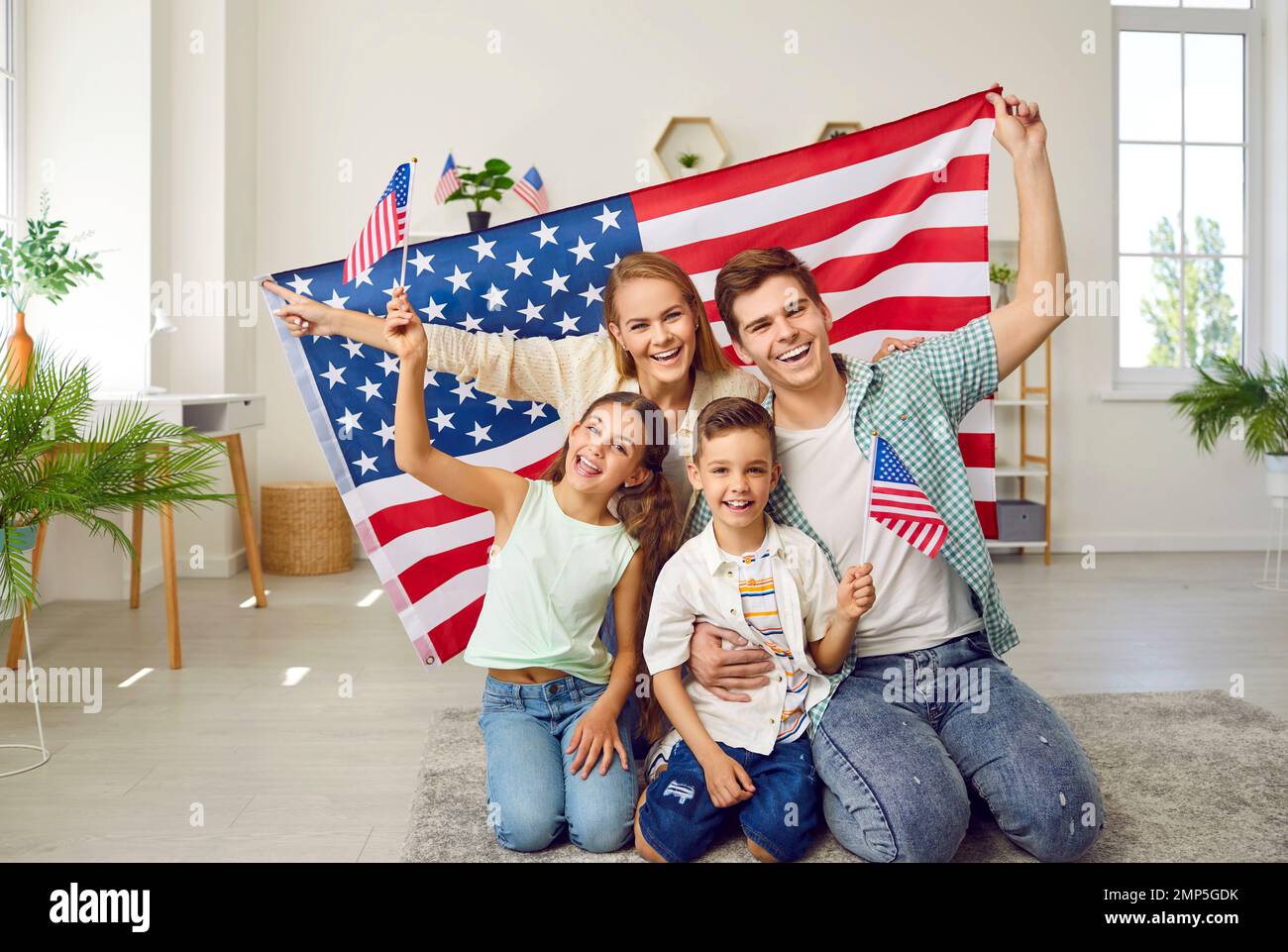 Portrait of happy American family with USA flag Stock Photo - Alamy