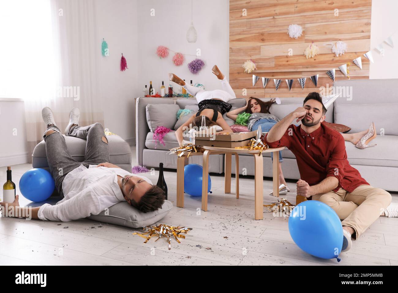 Drunk friends sleeping in messy room after party Stock Photo - Alamy