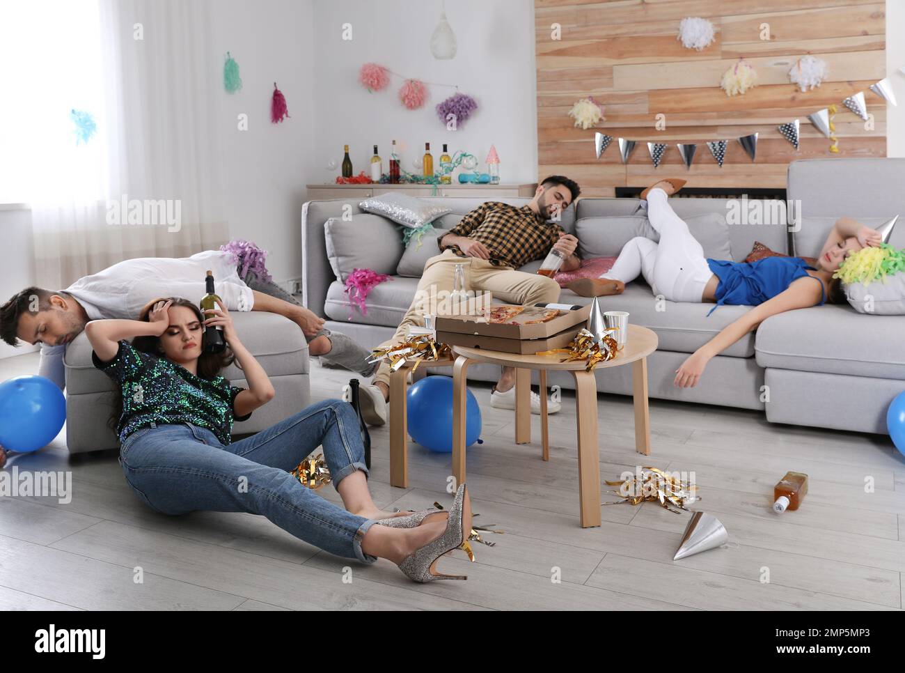 Drunk friends sleeping in messy room after party Stock Photo - Alamy