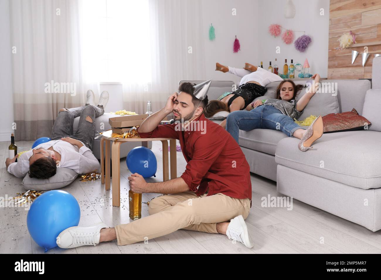 Drunk friends sleeping in messy room after party Stock Photo - Alamy