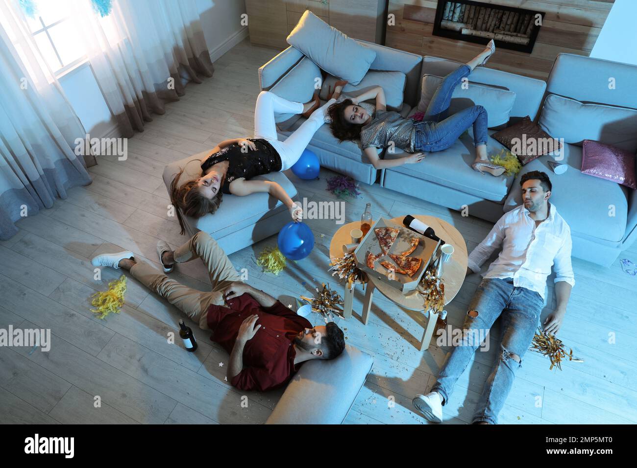 Drunk friends sleeping in messy room after party, above view Stock ...