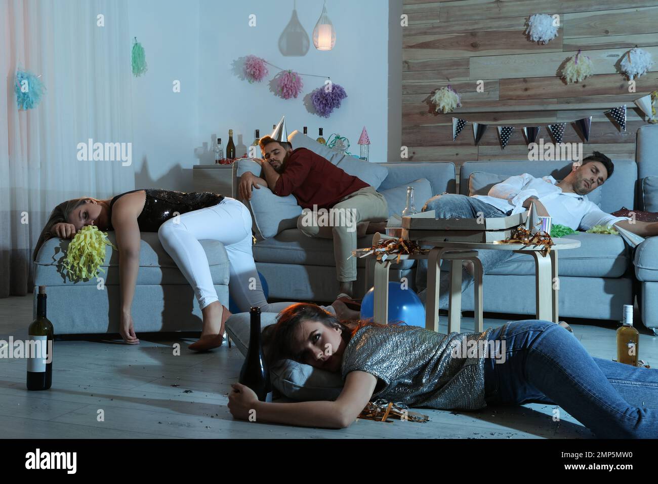 Drunk friends sleeping in messy room after party Stock Photo - Alamy