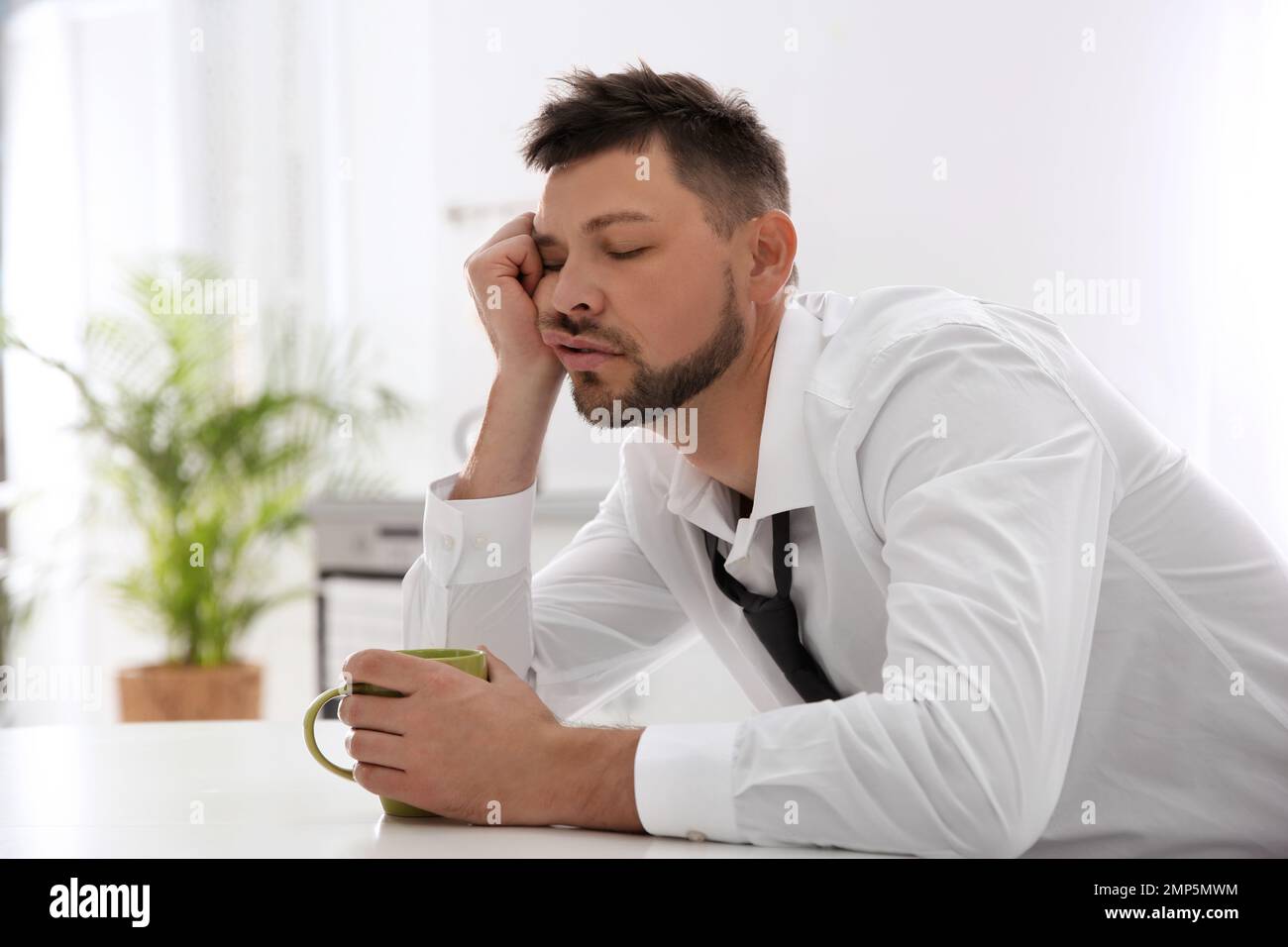 Sleepy man having cup tea hi-res stock photography and images - Alamy