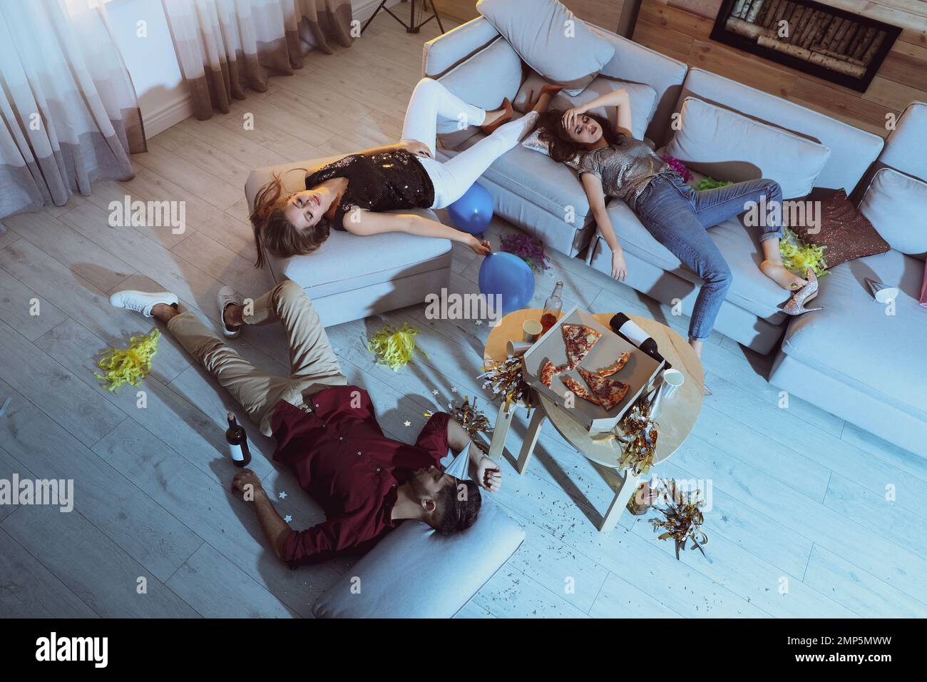 Drunk friends sleeping in messy room after party, above view Stock ...