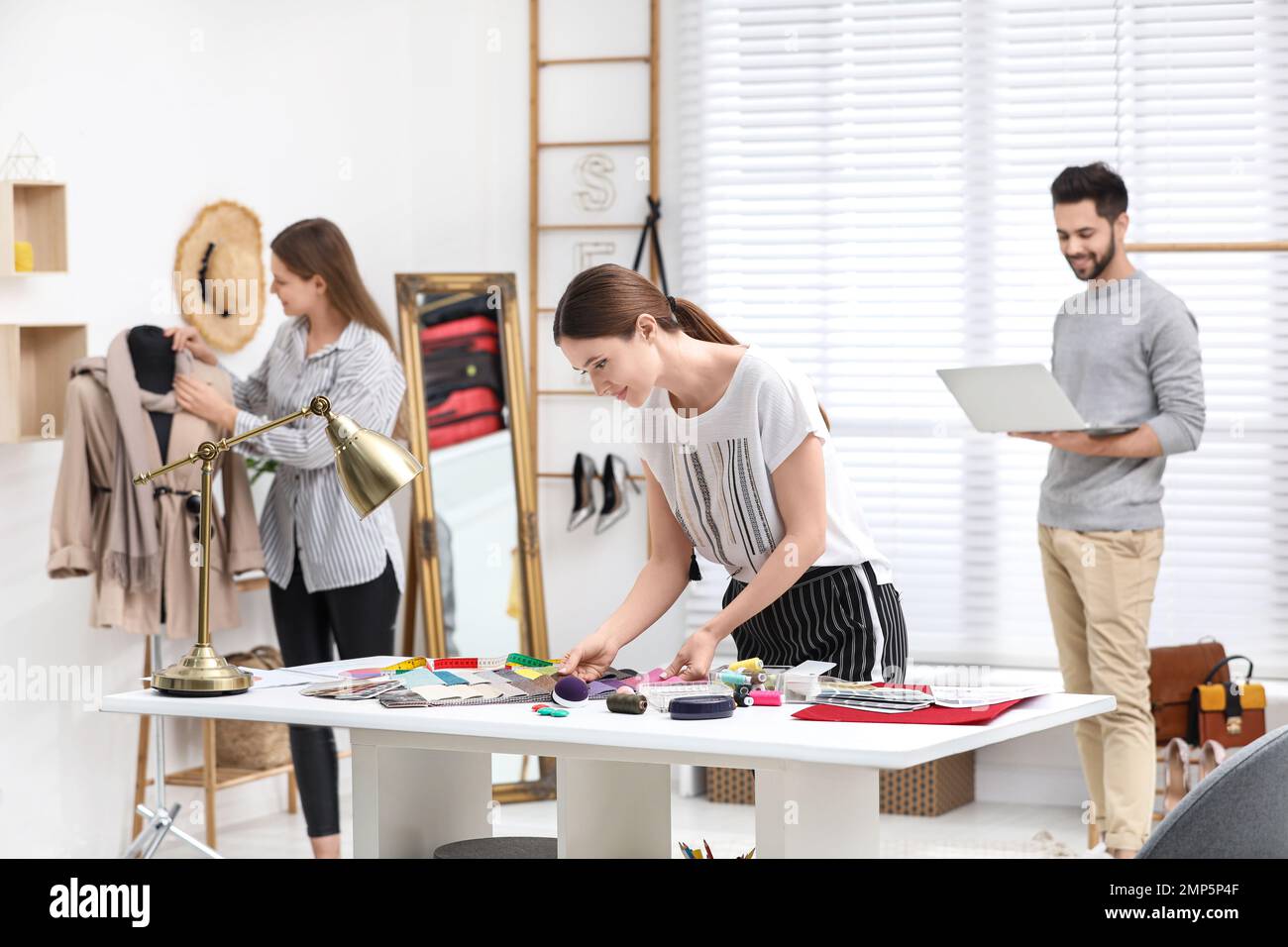 Fashion designers creating new clothes in studio Stock Photo - Alamy