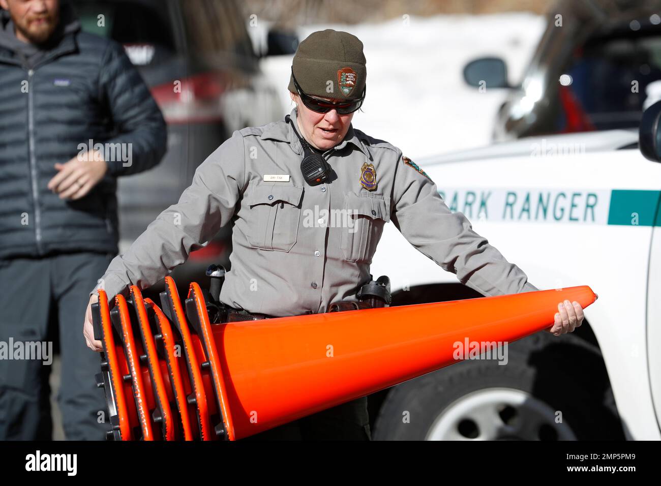 Park Ranger Amy Fink carries cones to use in the Bear Lake trailhead in ...