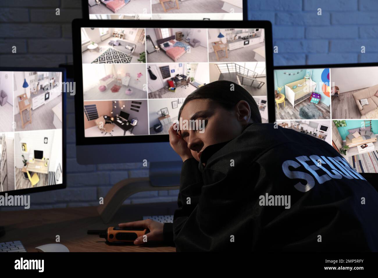 Female security guard sleeping near monitors at workplace Stock Photo ...