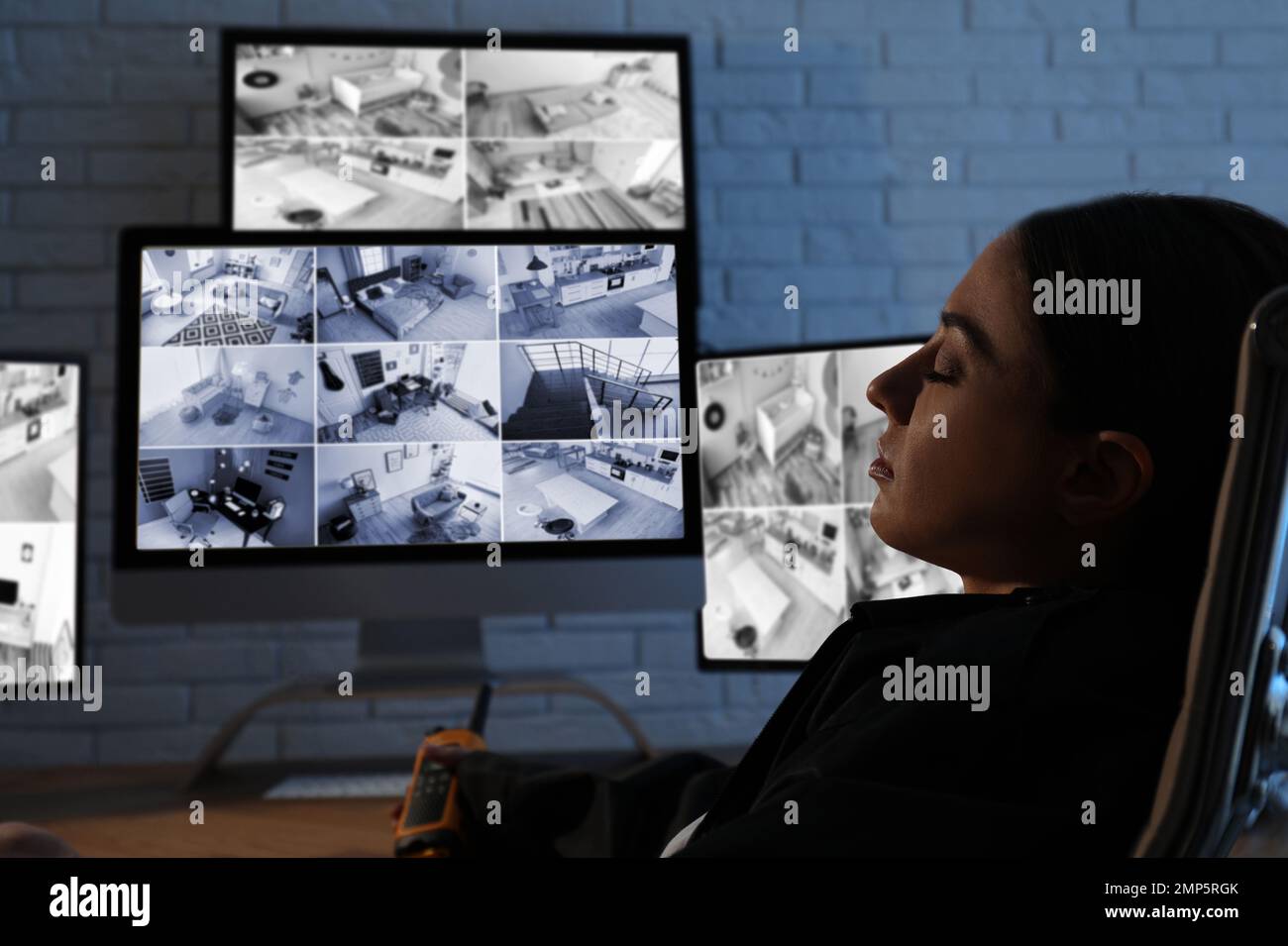 Female security guard sleeping near monitors at workplace Stock Photo ...