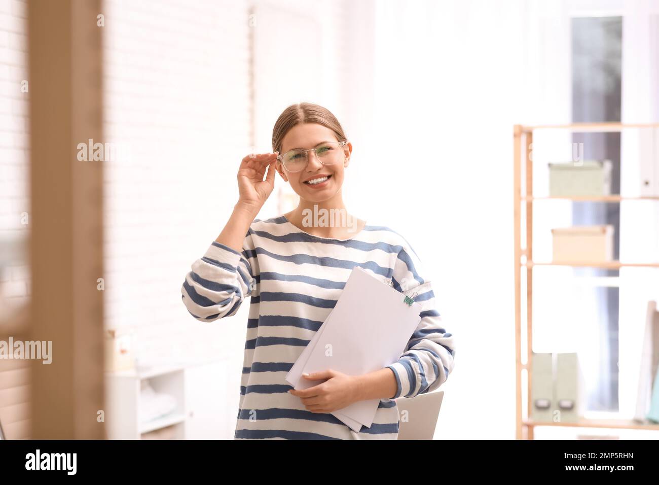 Young journalist at workplace in light office Stock Photo - Alamy