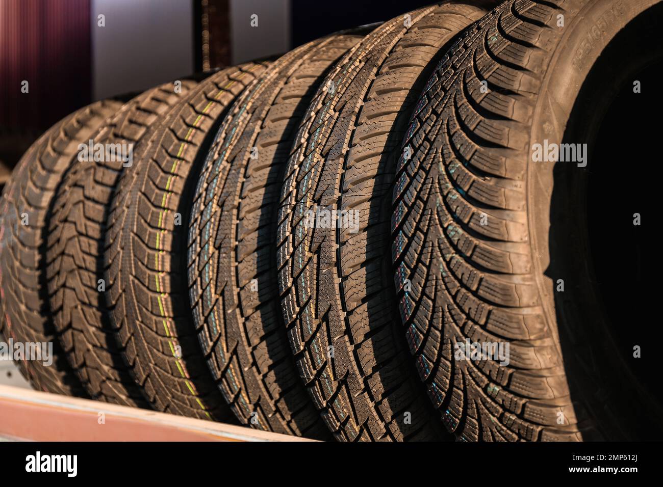 Row of tires on rack in store. Total wholesale Stock Photo - Alamy