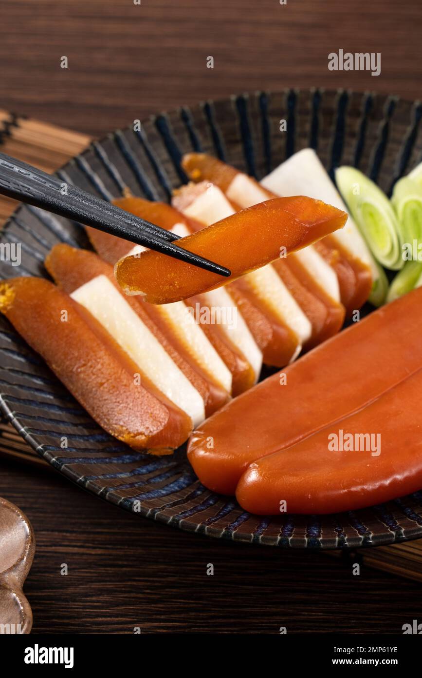 Delicious fresh mullet roe with white radish slices and garlic sprout ...