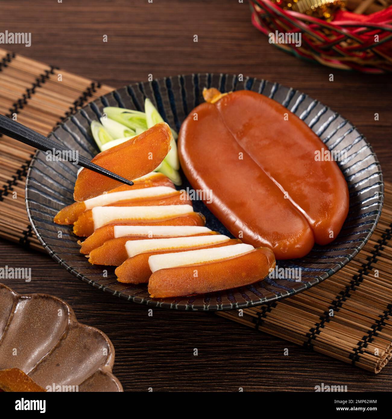 Delicious fresh mullet roe with white radish slices and garlic sprout ...