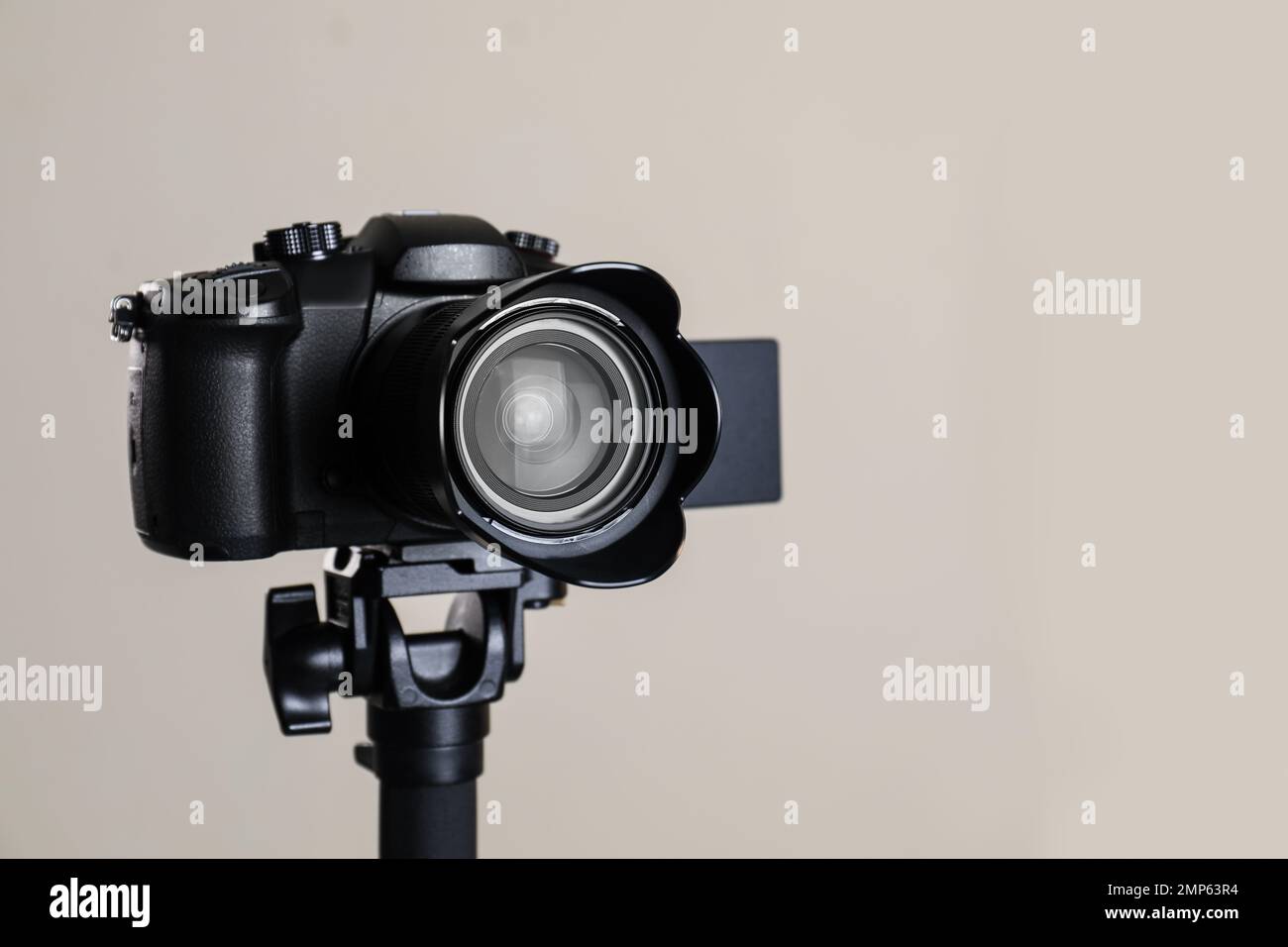 Modern professional video camera on beige background Stock Photo - Alamy