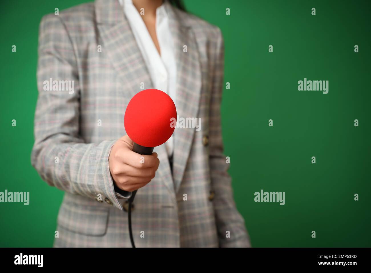 Journalist with microphone on green background, closeup. Space for text ...