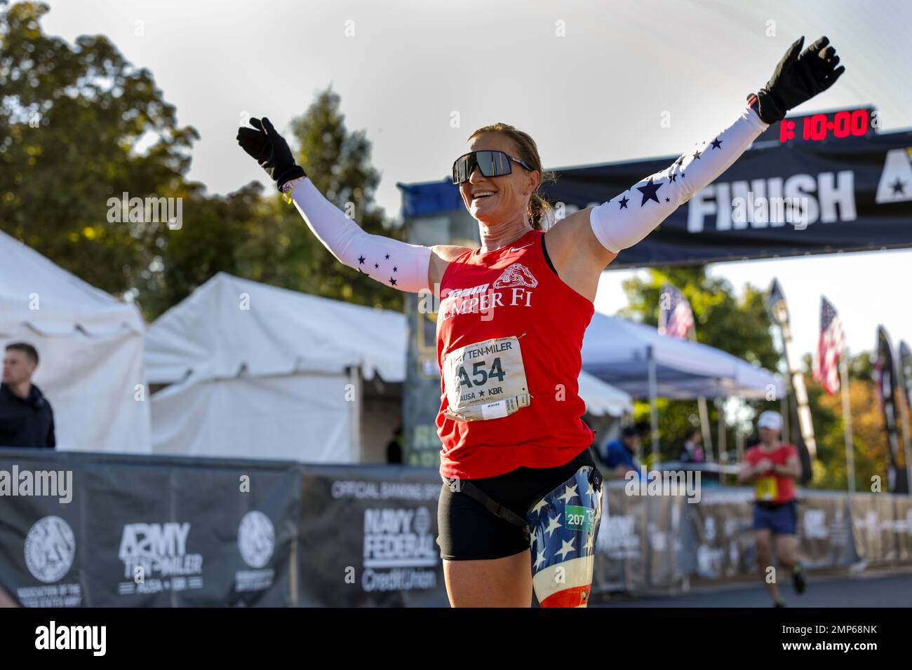 Runners cross the finish line during the Army 10-Miler Race Oct. 9 ...