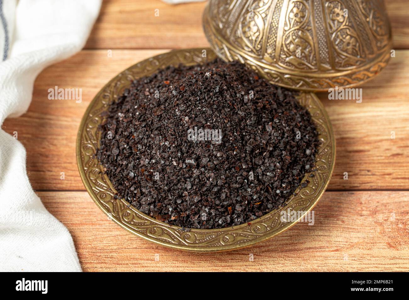Black hot pepper spice in bowl. Chili pepper is a hot spice obtained by ...