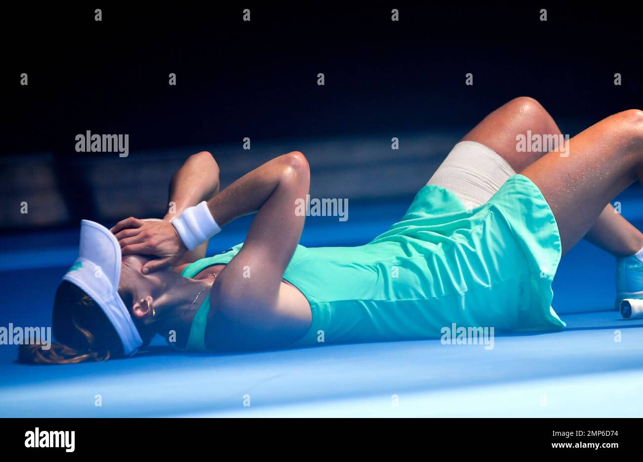 France's Alize Cornet falls to the court after suffering from the heat ...