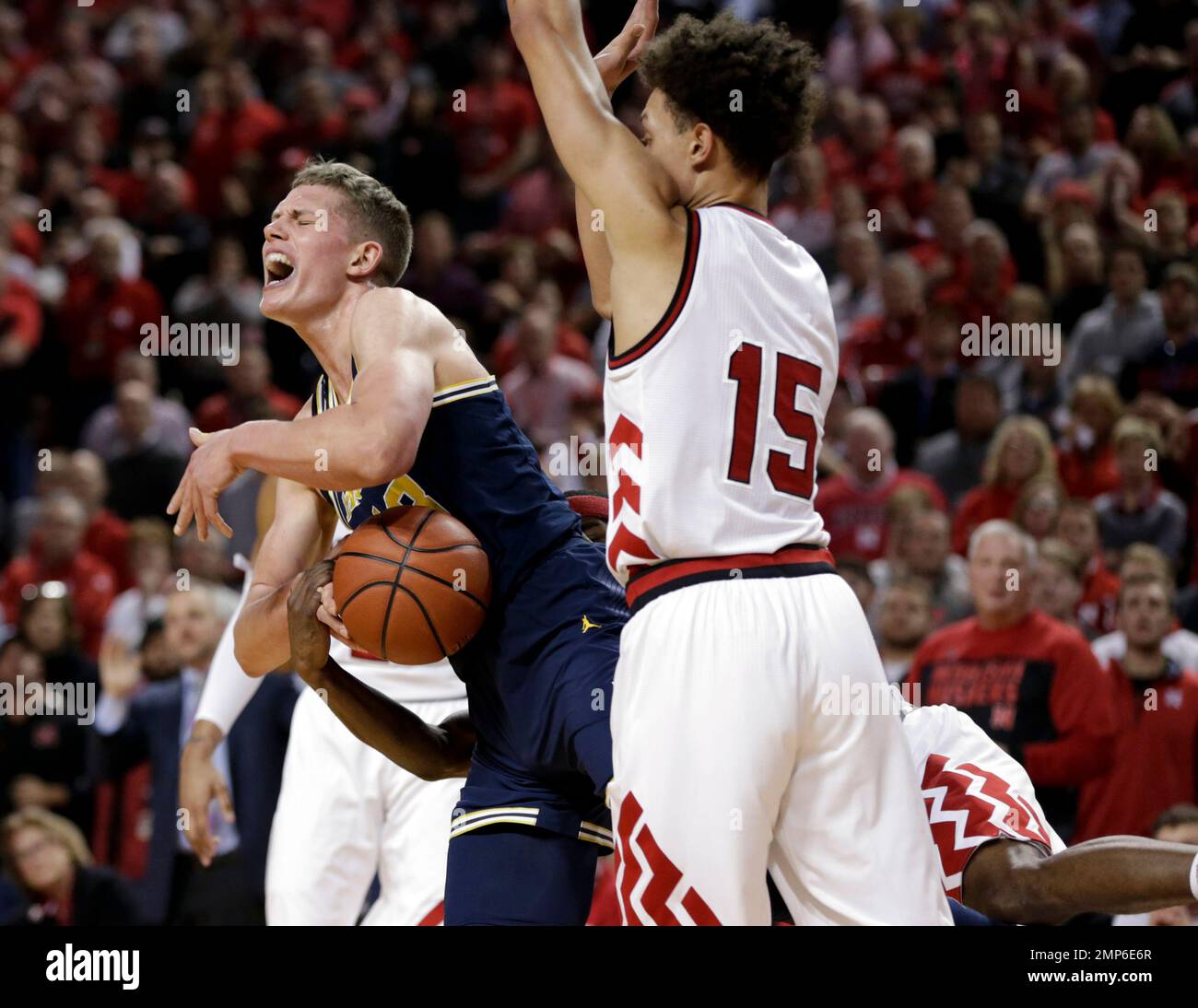 Michigan's Moritz Wagner (13) is fouled by Nebraska's Glynn Watson Jr ...
