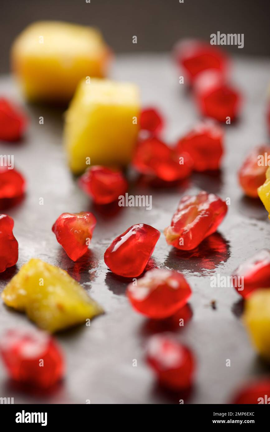 Pineapple chunks and pomegranate seeds on a black slate Stock Photo - Alamy