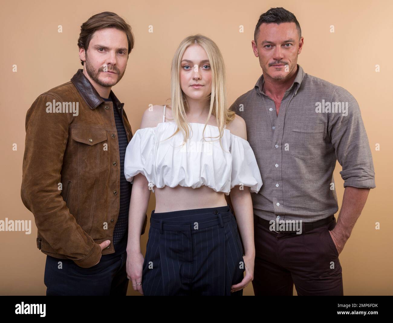 Daniel Bruhl, from left, Dakota Fanning and Luke Evans cast members in ...