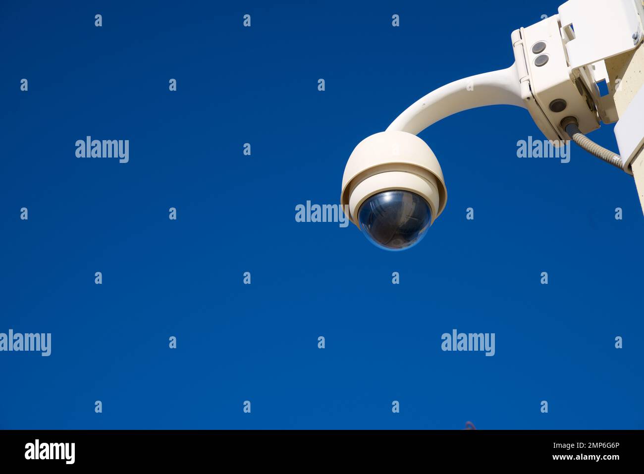 Closeup of a surveillance camera and clear sky Stock Photo - Alamy