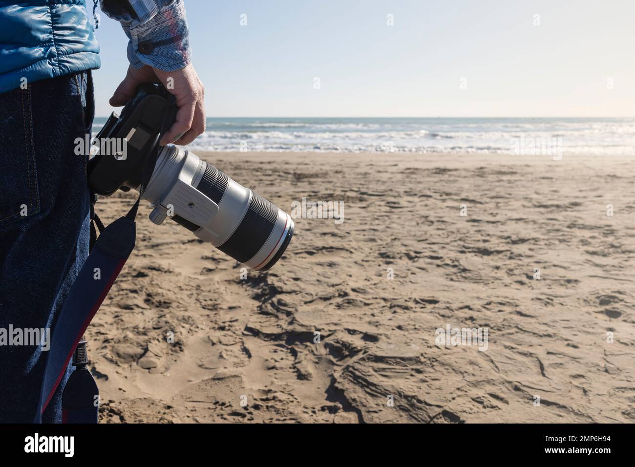 Photographer ready to take horizon photos on the beach. Professional ...