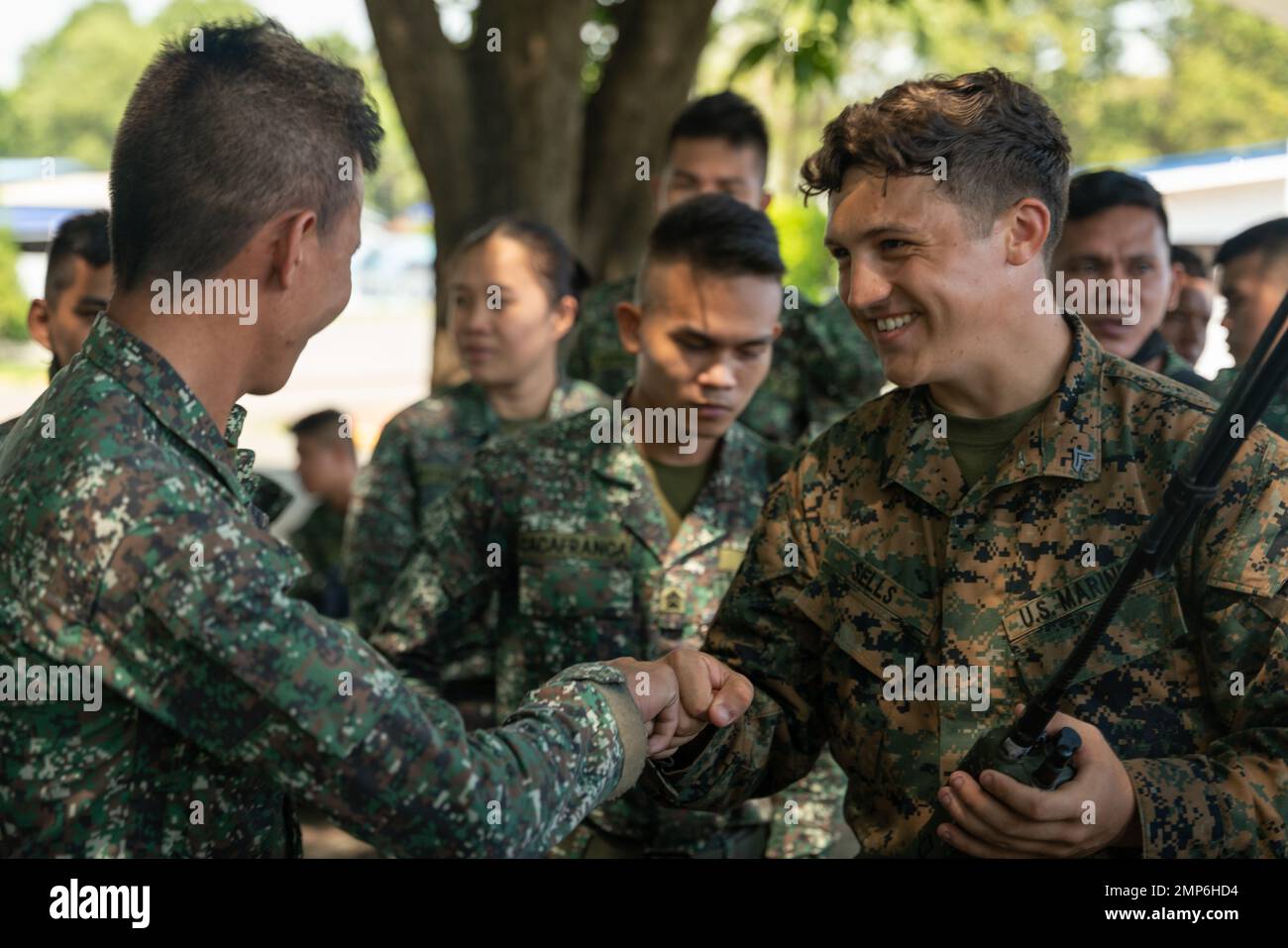 U.S. Marine Corps Cpl. Brandon Sells (right), a radio operator with 3d Marine Division, and a ...