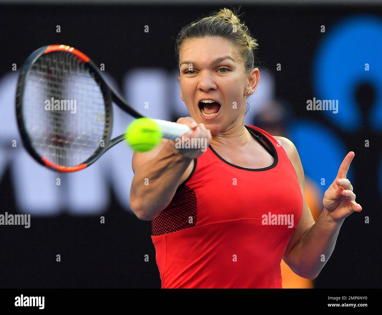 Romania's Simona Halep makes a forehand return to Canada's Eugenie ...