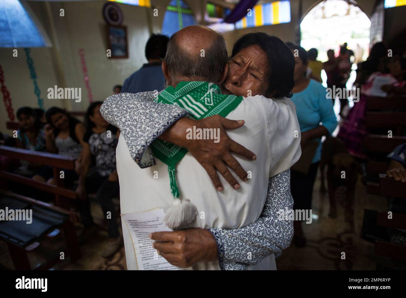 In this Jan. 14, 2018 photo, parishioner Lucero Fatima Cusi embraces ...