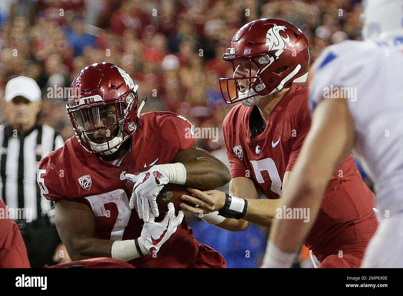 Washington State quarterback Tyler Hilinski, right, hands the ball off ...