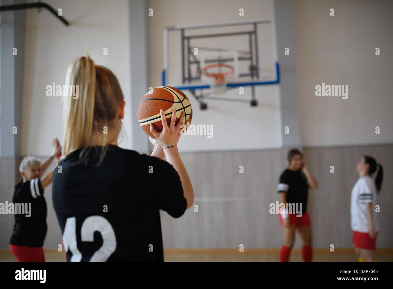 Young woman basketball player in gym, throwing ball in basket Stock ...
