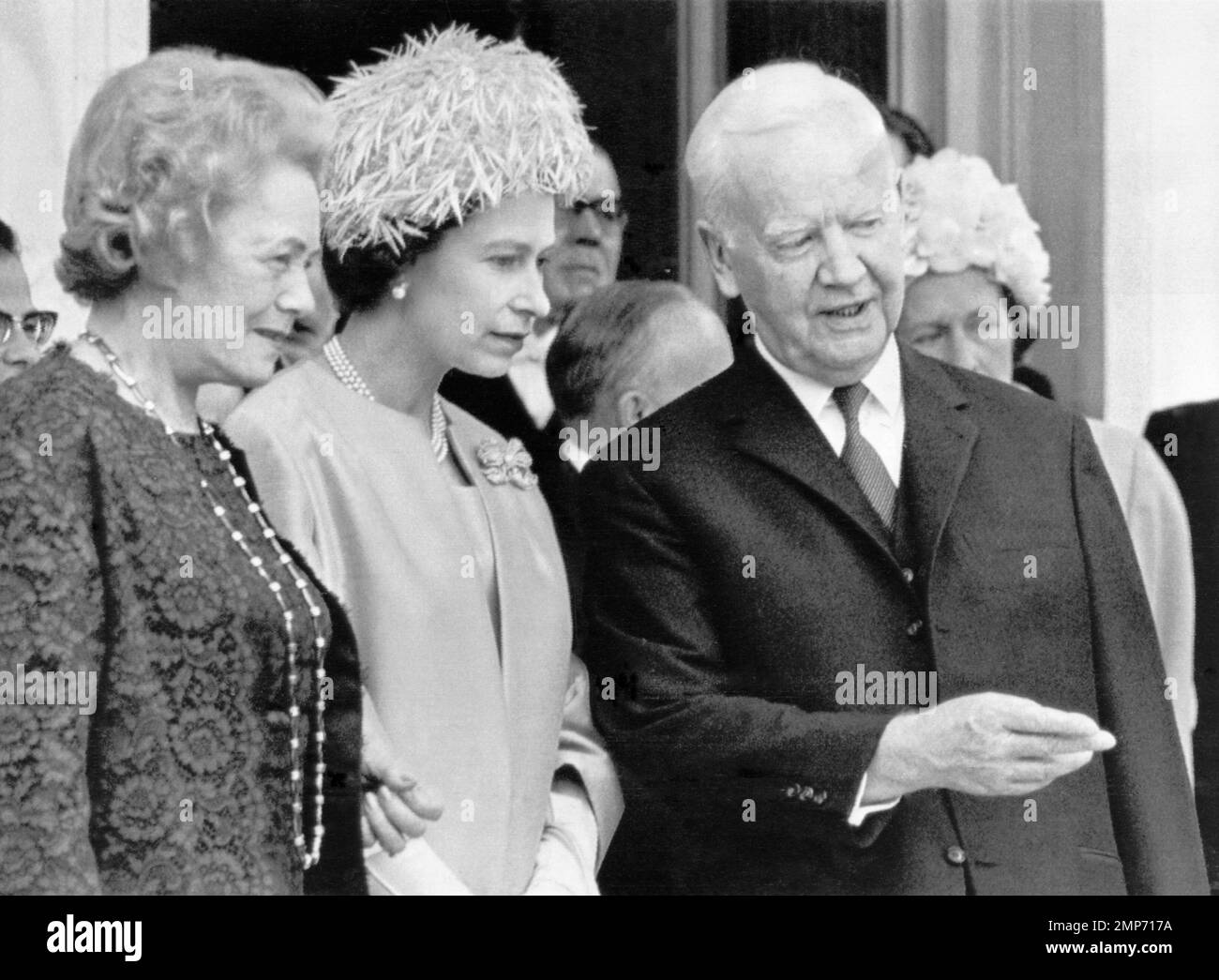 Queen Elizabeth II is flanked by west German President Heinrich Lubke ...