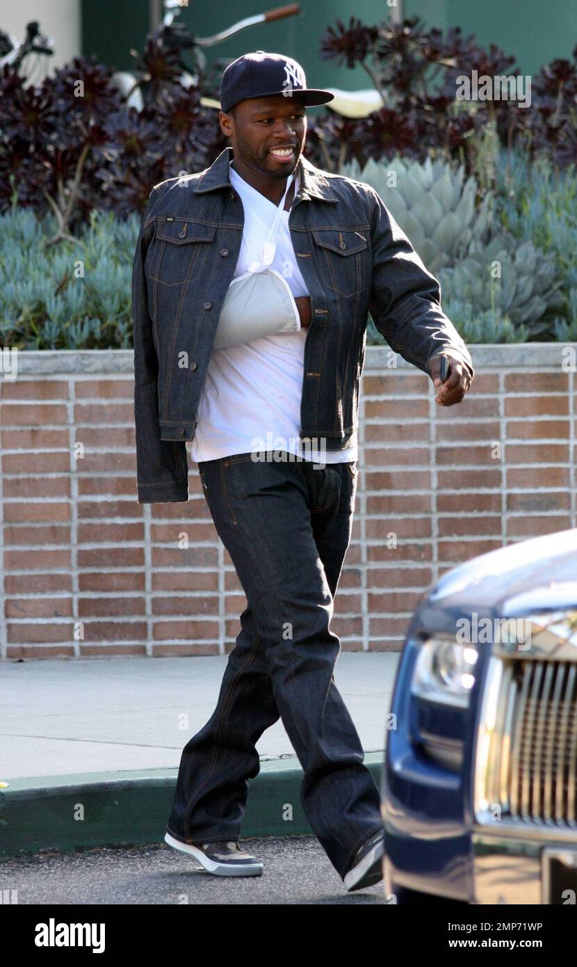 Rapper 50 Cent leaves the "Chelsea Lately" show studios with his arm in ...