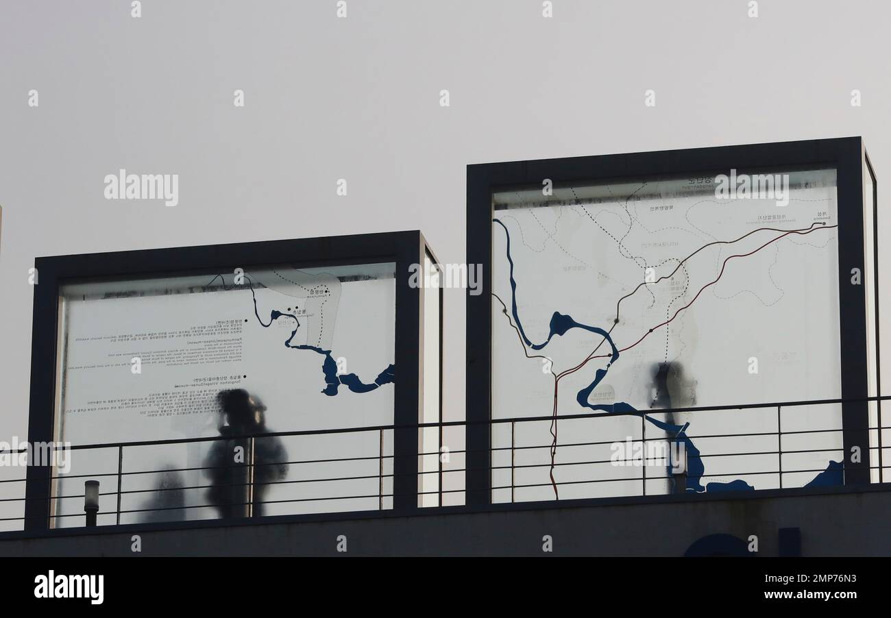 A visitor watches the north side through the glass showing a map of ...