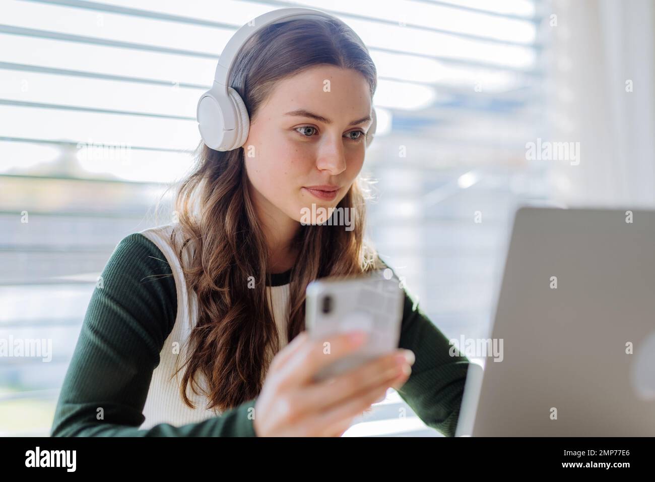 Young woman having distance education in her apartment Stock Photo - Alamy