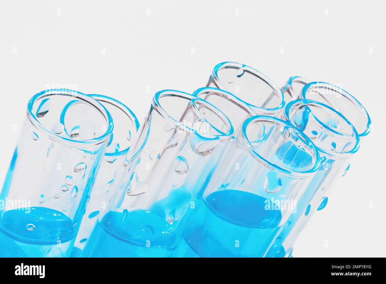 Transparent glass test tubes on a white background, blue liquid ...