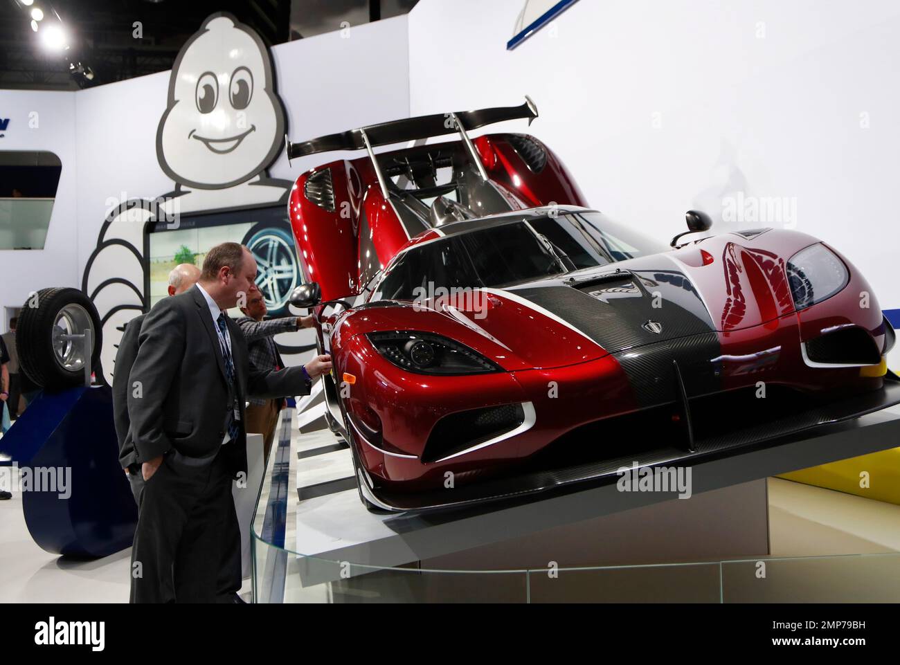 Visitors look over a Koenigsegg Agera RS car on display at the Michelin ...