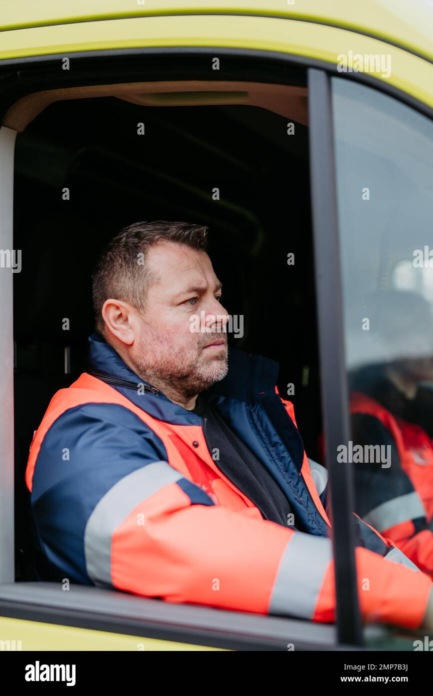 Portrait of rescuer doctor sitting in ambulance car Stock Photo - Alamy