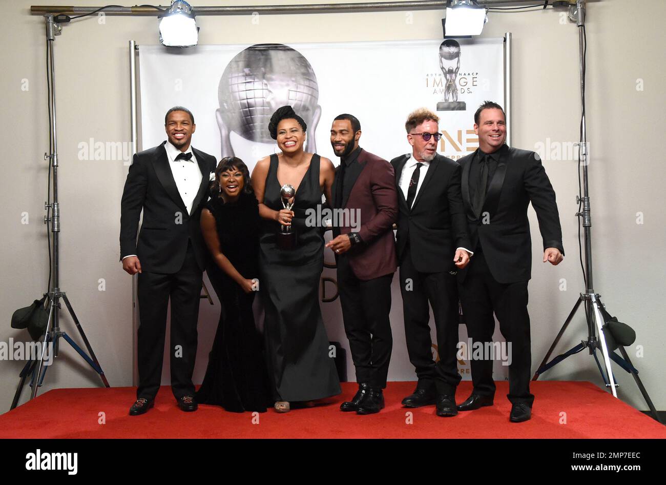The cast and crew of "Power" pose in the press room with the award for ...