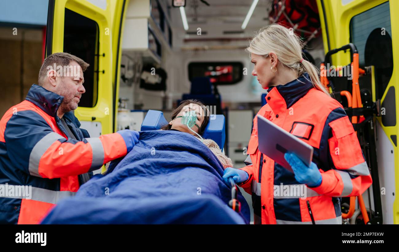 Rescuers taking care of patient, preparing her for transport Stock ...