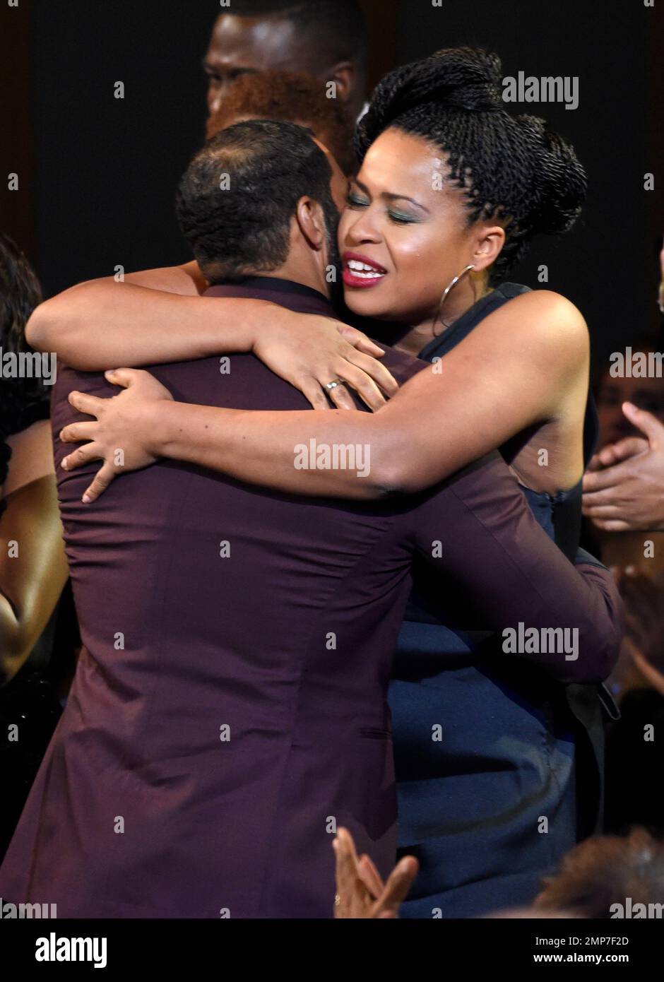 Courtney Kemp Agboh, right, hugs Omari Hardwick as he accepts the award ...