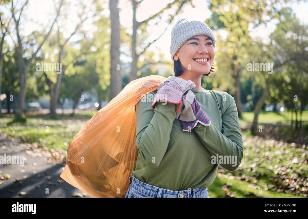 Plastic bag, park and woman cleaning in eco friendly, climate change or community service ...
