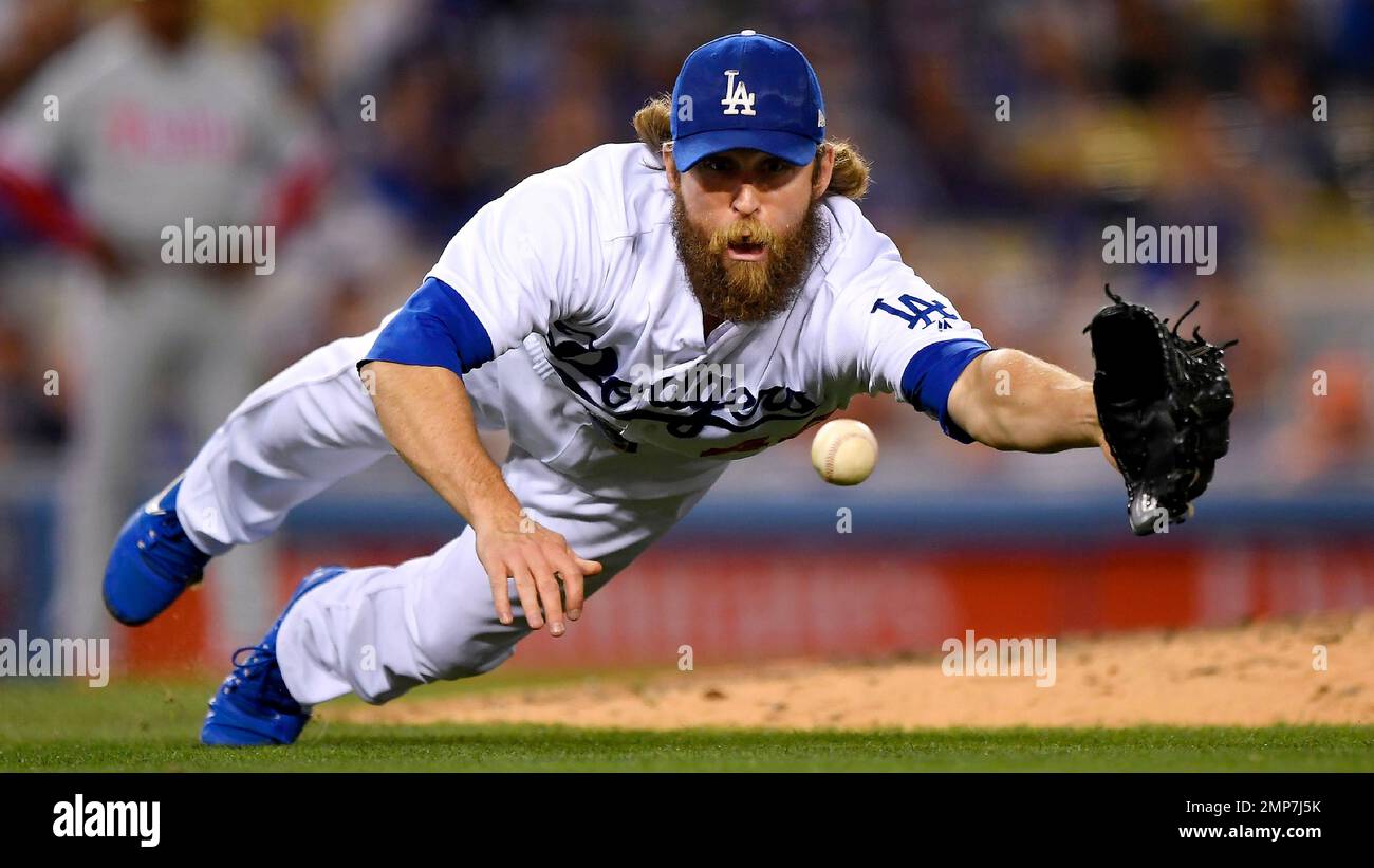 Los Angeles Dodgers relief pitcher Josh Fields dives for a ball hit for ...