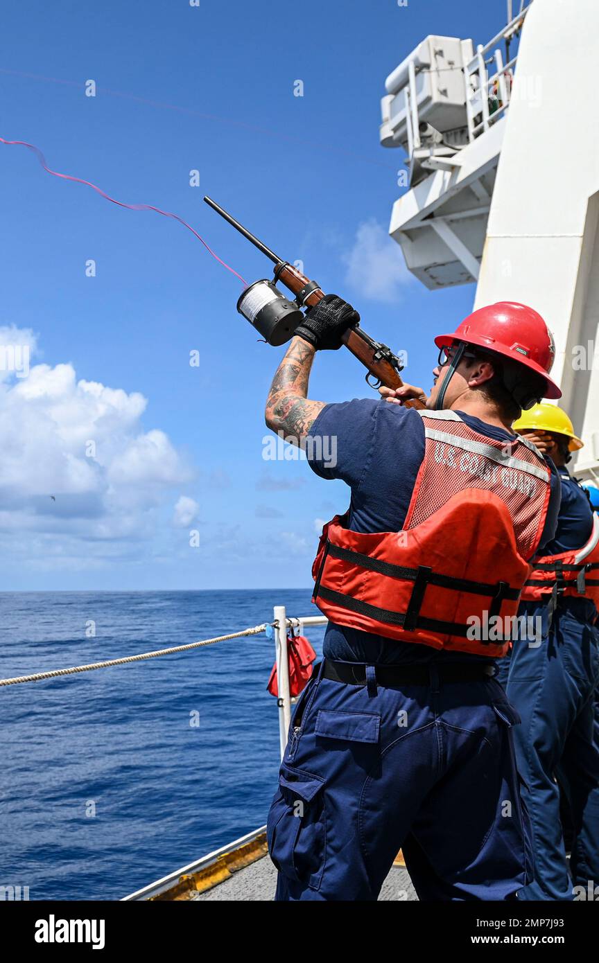 Petty Officer 2nd Class Kevin De La Rosa fires a tag line from U.S ...