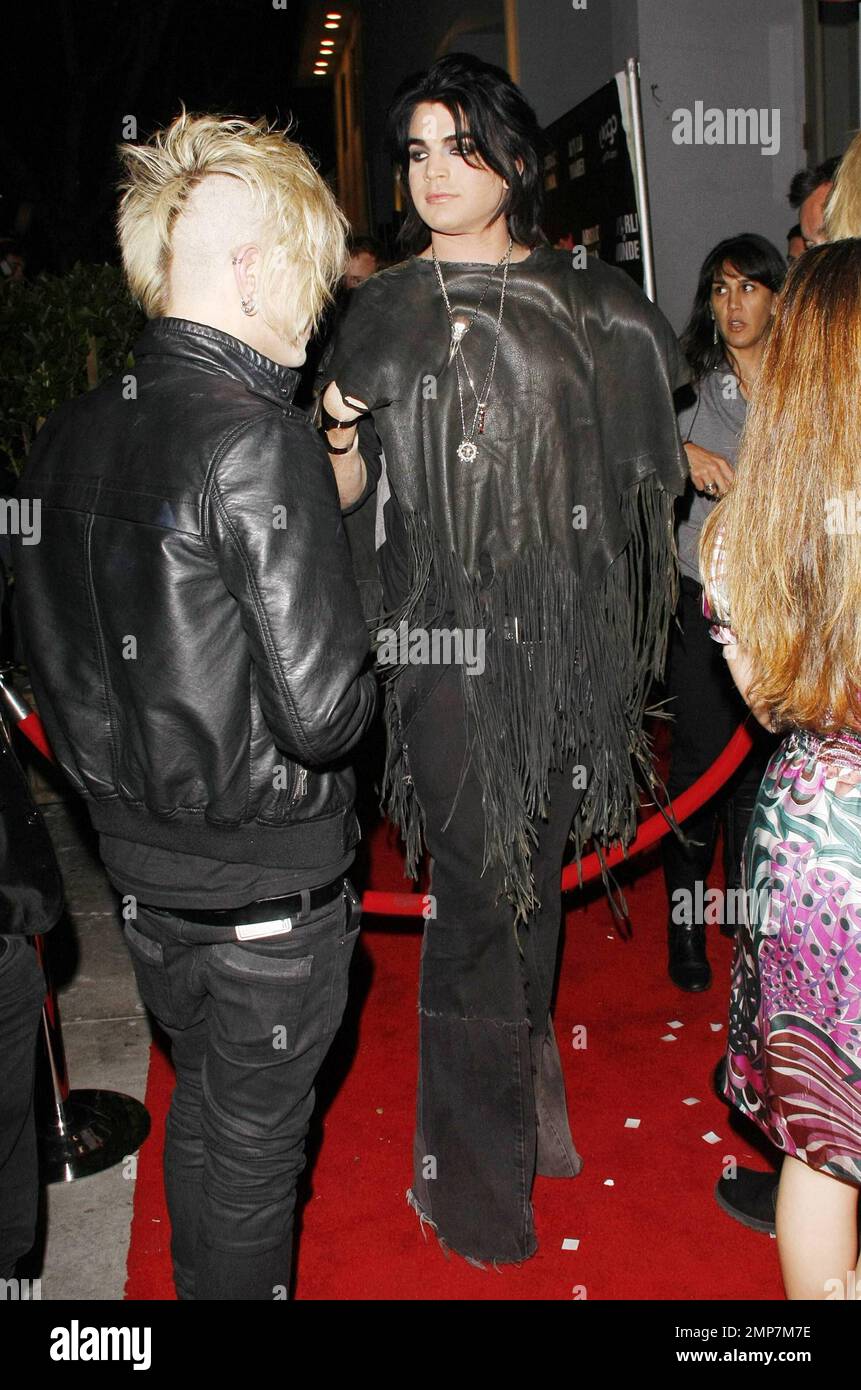 Pop singer Adam Lambert smiles and chats with friends as he arrives at ...