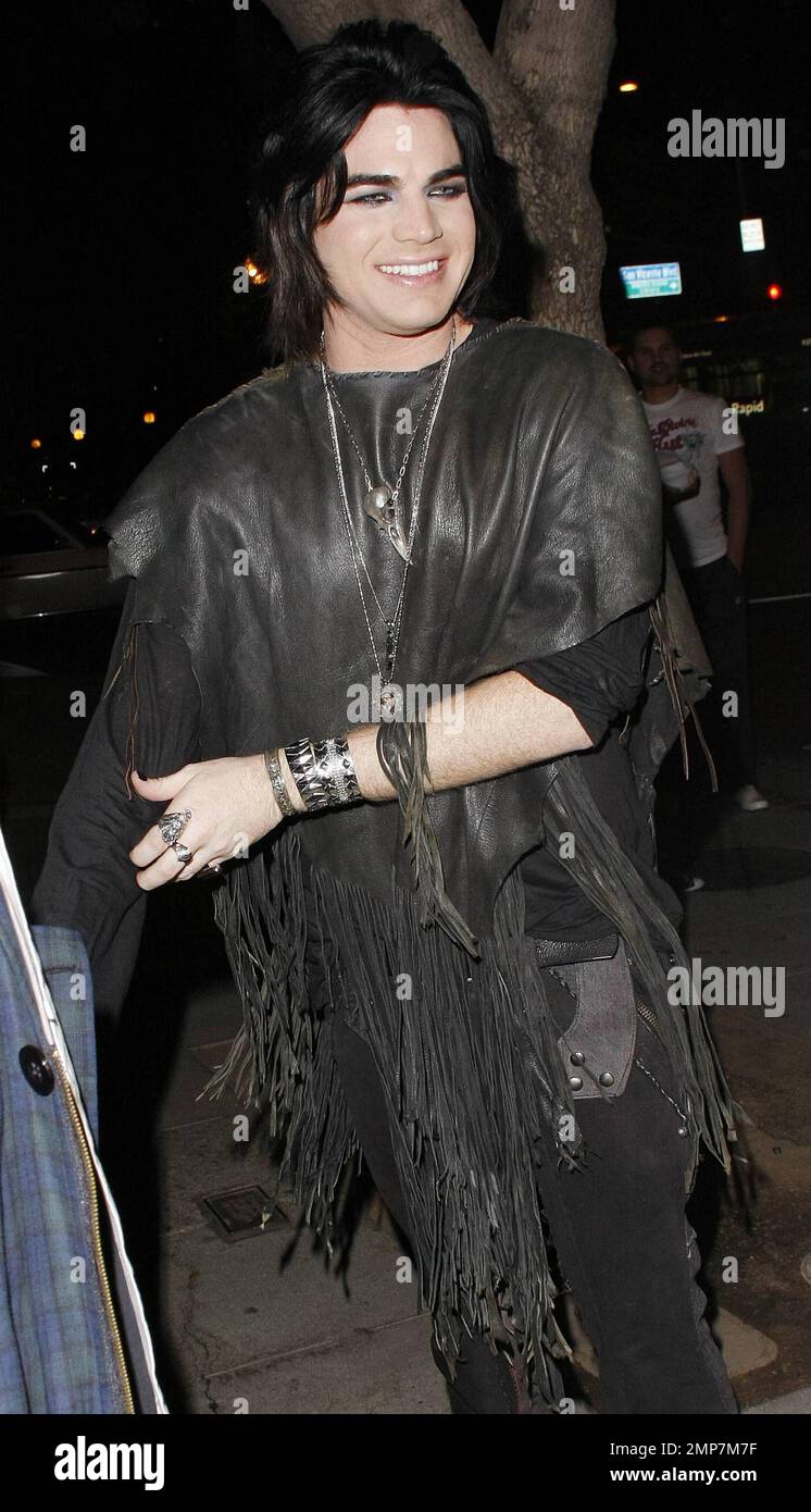 Pop singer Adam Lambert smiles and chats with friends as he arrives at ...