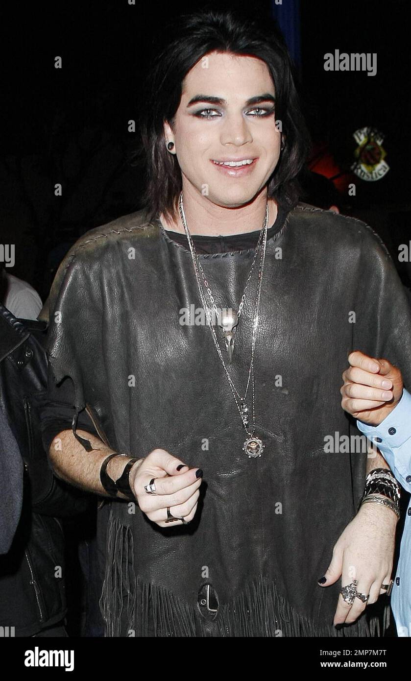 Pop singer Adam Lambert smiles and chats with friends as he arrives at ...
